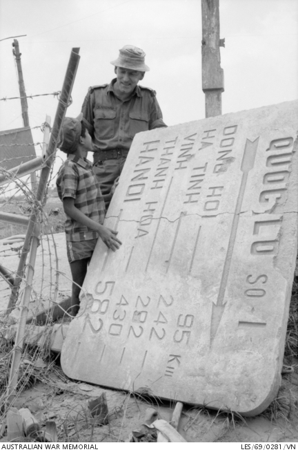 Quang Tri, South Vietnam. 1969-05. This signpost, damaged during a rocket attack, brings home to ...