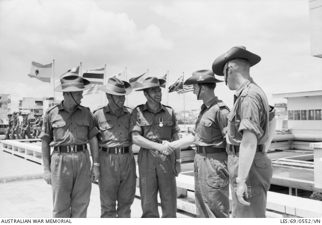 Warrant Officer Class 2 (WO2) Bill Grogan of Plympton, SA, is congratulated by Major (Maj) Alex ...