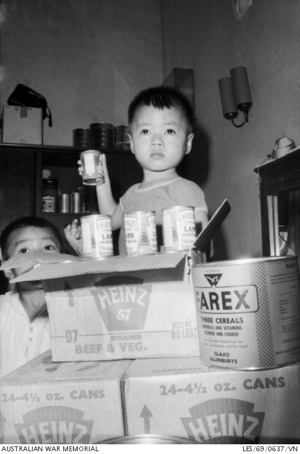 Two Vietnamese orphan boys display the contents of a box of Heinz baby ...