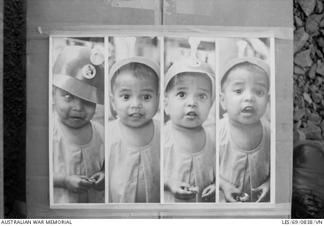 Portrait of a Vietnamese orphan girl wearing a toy hat at a Christmas ...