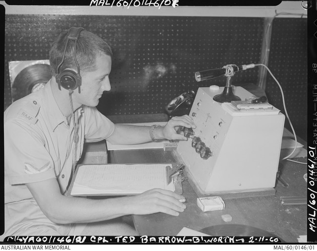 A RAAF serviceman working a radio set at the communications centre at ...