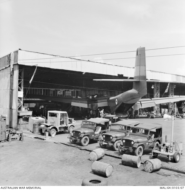 An RAAF Caribou being serviced in the foreground, while in the rear is ...