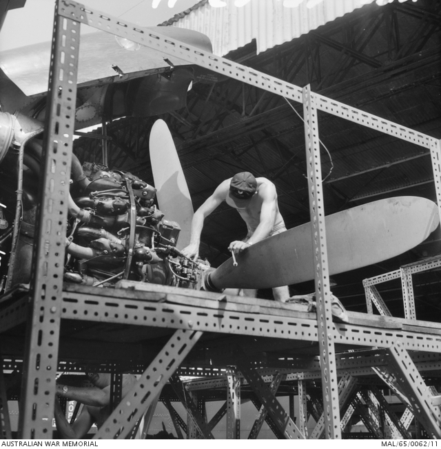 A RAAF engine fitter is framed by a locally-built Dexion working ...