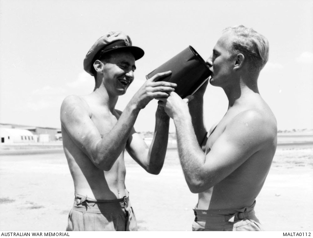 Corporal (Cpl) Bill Daw of Port Melbourne, Vic (left) gives a welcome ...