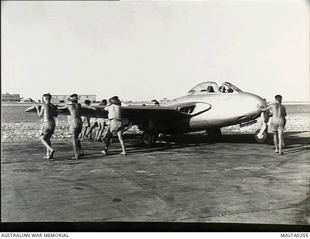 Surveying crews handling a Vampire fighter aircraft at the Malta base ...