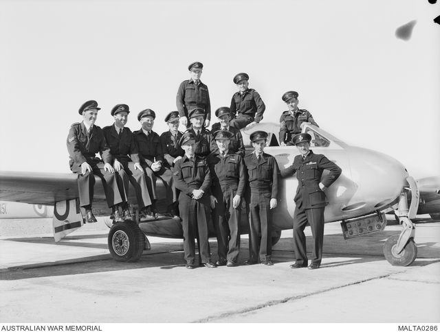 Group portrait of members of 78 Fighter Wing RAAF posing on and beside ...