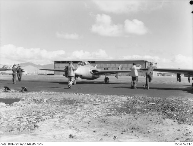 Ground staff of 78 Fighter Wing RAAF marshalling in a Vampire jet ...