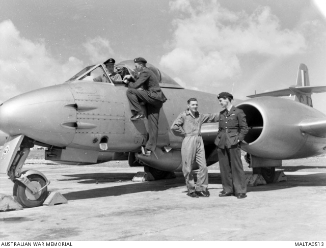 Two pilots of 78 Fighter Wing RAAF looking at a Meteor Eight fighter ...