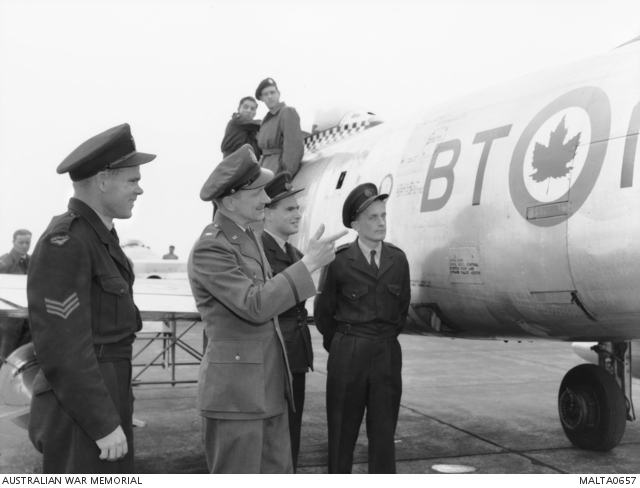 American pilots and Australian ground staff look at the maple leaf ...