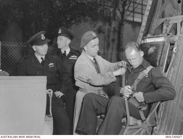 An RAF instructor straps Flying Officer (FO) Reg Jones of North Sydney ...