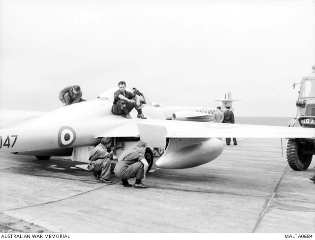 Unidentified ground staff of 78 Fighter Wing RAAF work on one of the ...