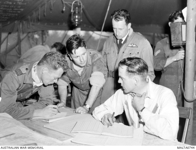 Three pilots from 78 Fighter Wing RAAF have a discussion while their ...