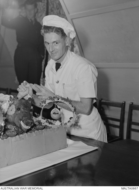 RAAF cook Corporal Percy Harmer of Belmore, NSW, puts the final touches ...