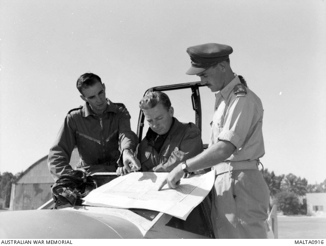 Two pilots of 78 Fighter Wing RAAF are briefed by the Wing's Ground ...
