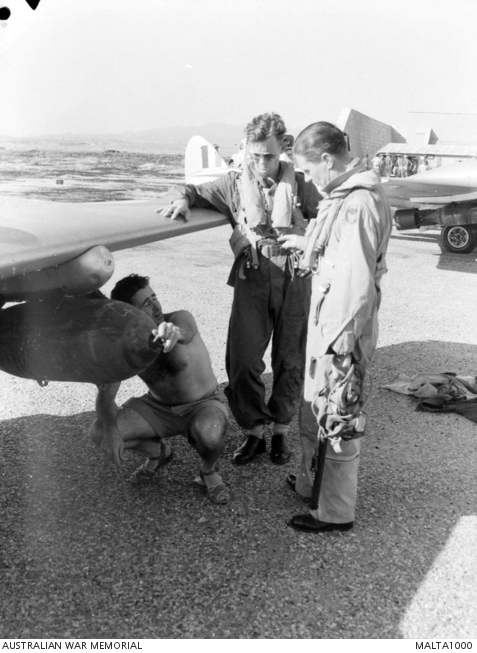 Two pilots with 78 Fighter Wing RAAF chat with a senior armourer before ...