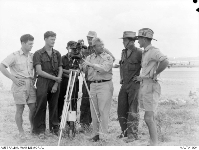 Five ground staff from 78 Fighter Wing RAAF watch an American cameraman ...