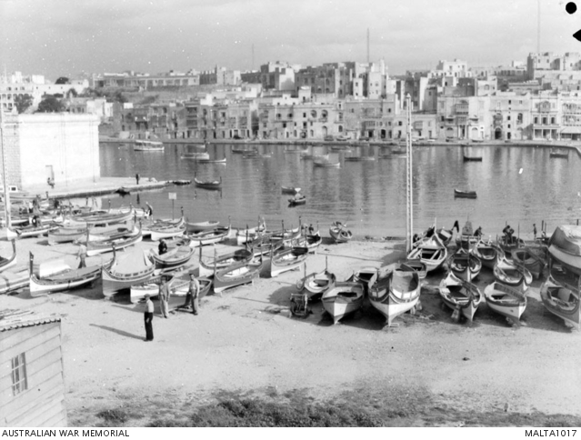 The port in a Maltese town, with a variety of small vessels in the ...