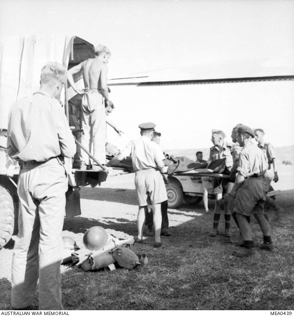 Sicily, Italy. 1943. RAAF medical personnel lift a stretcher case into ...