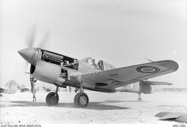 Malta. c. July 1943. A Curtiss P40 Kittyhawk aircraft of No. 3 Squadron RAAF being checked after ...