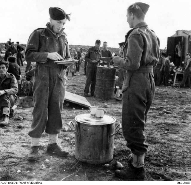 El Agheila, Cyrenaica, Libya. 7 December 1942. At meal time some airmen ...