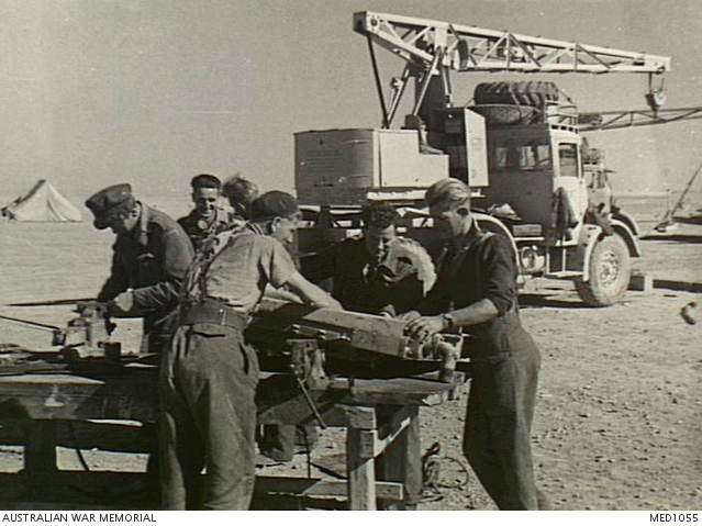 Using a desert work bench, fitters repair a radiator at the maintenance ...