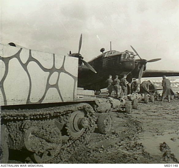 A Bren gun carrier is used on one airfield for towing trolley loads of ...