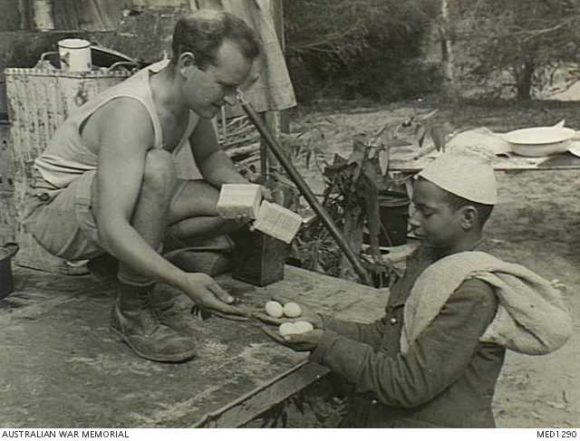Tripolitania, Libya. 17 February 1943. A native boy brings fresh eggs ...