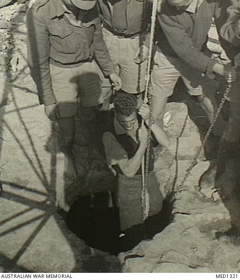 Tripolitania, Libya. 23 February 1943. The diviner goes down to inspect ...