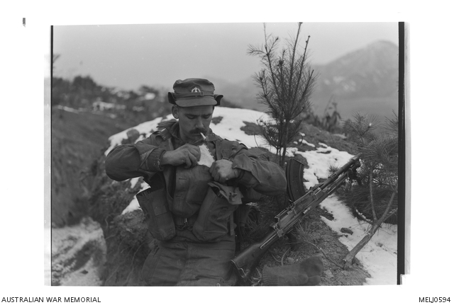 Men of the 1st Battalion, The Royal Australian Regiment (1RAR), along ...