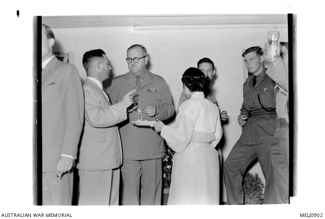 A Korean girl in traditional national dress serves savouries to ...