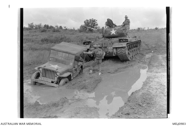 An American Patton tank comes to the rescue of a bogged Australian jeep ...