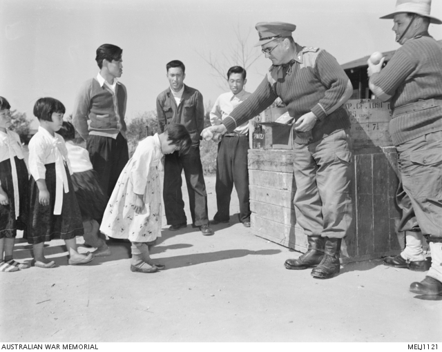 Korean schoolchildren living in a village adjoining the truce line camp ...