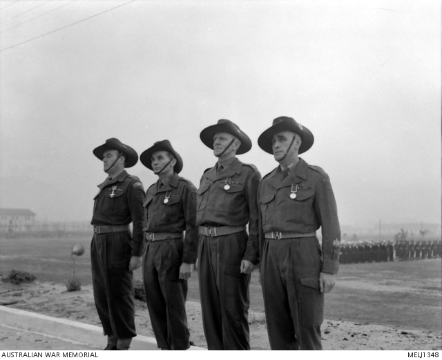 Three officers and one warrant officer are wearing their medals after ...