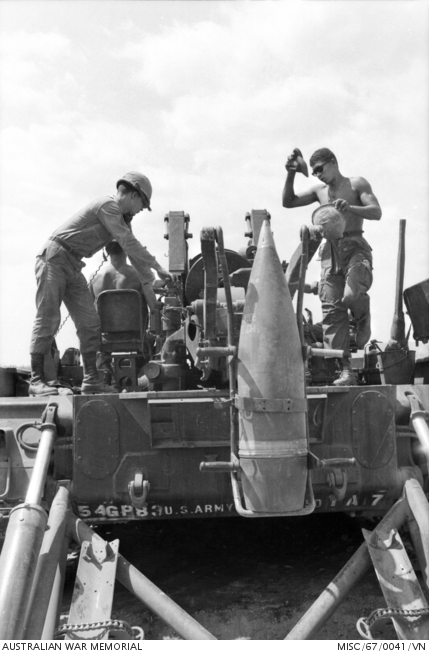 Soldiers loading an US Army 8 inch self-propelled gun (SPG). Note the ...