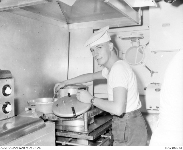 Cook Donald Watters of Blaxland, NSW on duty in a ship's galley in the ...