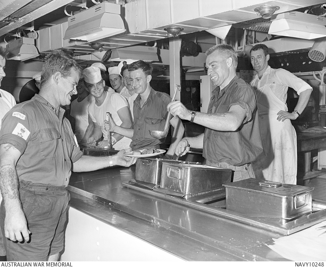 An Army cook, en route to serve in Vietnam with an embarked military ...