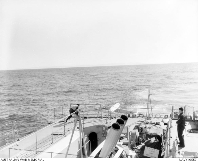 Two unidentified sailors assist with preparations for the launch of a ...