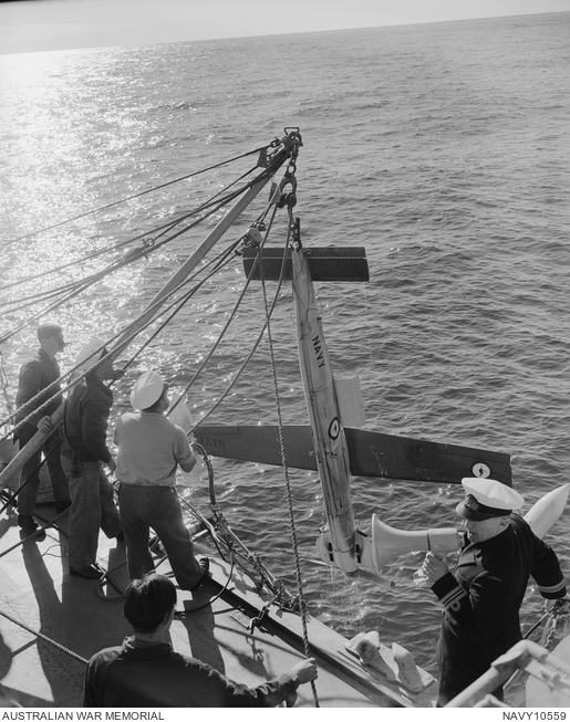 A trials team employs a derrick in recovering a Pilotless Target ...