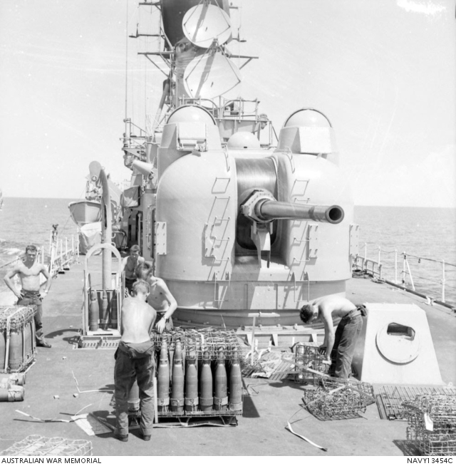 Several unidentified sailors handle palletted ammunition on the Mount ...