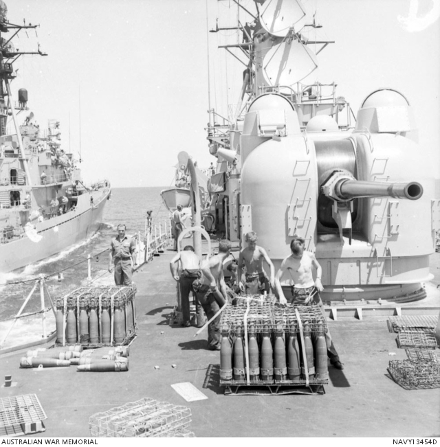 Several unidentified sailors handle palletted ammunition on the Mount ...