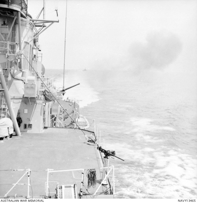 Smoke appears from the Mount 52 of the Guided Missile Destroyer HMAS ...