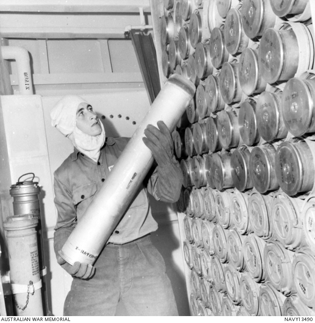 Ordinary Seaman Barry Stringer, R65609 removes a cartridge case from ...
