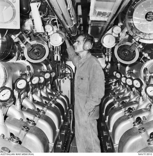An unidentified crew member checks gauges in the engine room of an ...