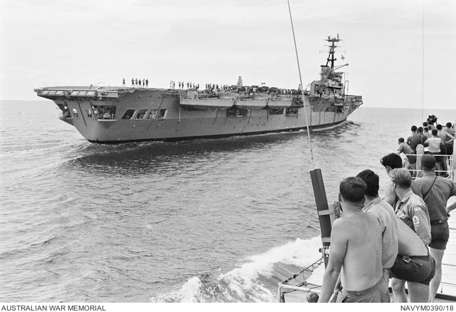 Sailors on the deck of the RAN escort ship HMAS Stuart DE 48, observe ...