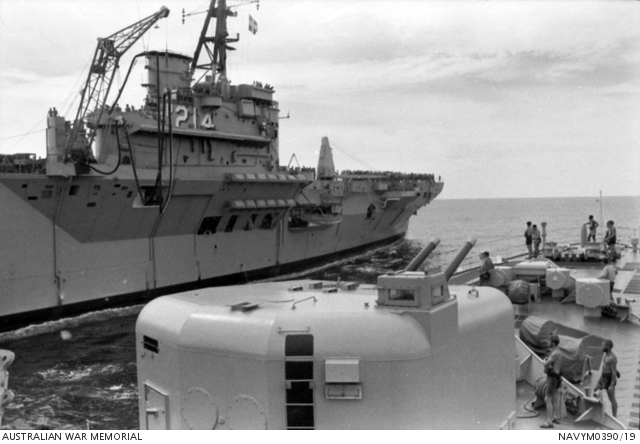 Sailors on the deck of the RAN escort ship HMAS Stuart DE 48, observe ...