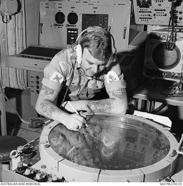 A leading seaman radar plotter aboard HMAS Torrens. Note tattooed arms ...