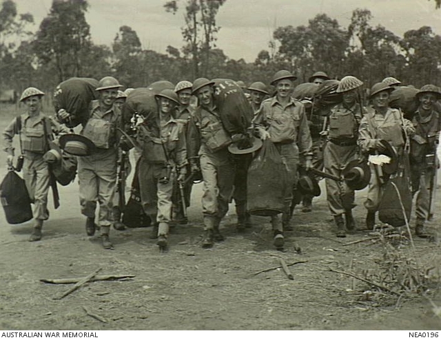 North Qld. C. 1943-11. Members of a RAAF repair and salvage unit, with their kitbags, moving out ...
