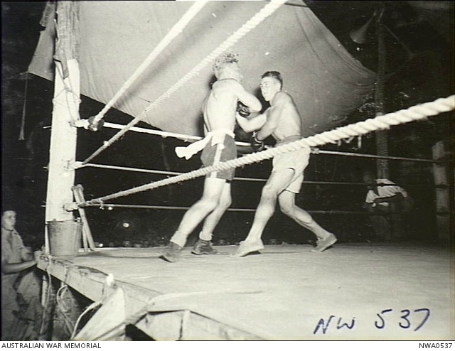 39 Mile, NT. 1943-12-31. In the boxing ring at a combined Navy, Army ...