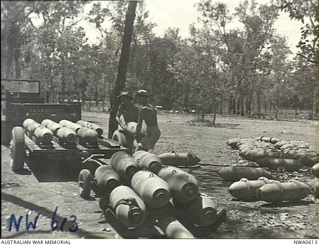 Manbulloo, NT. c. September 1944. Ground staff loading bombs onto a ...