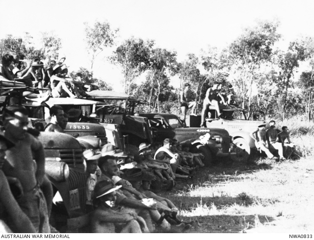 Darwin, NT. 1945-04-21. A group of spectators sitting on and around ...